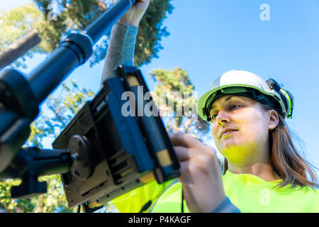 woman surveyor, civil engineer using a theodolite Stock Photo - Alamy