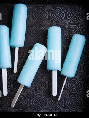 Blue ice lollies on a metal surface Stock Photo - Alamy