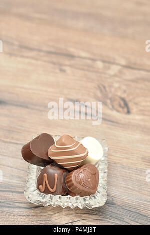 A variety of chocolates displayed in a fancy glass container Stock ...