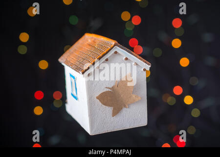 Paper butterfly on a Model house on a bokeh light Stock Photo - Alamy