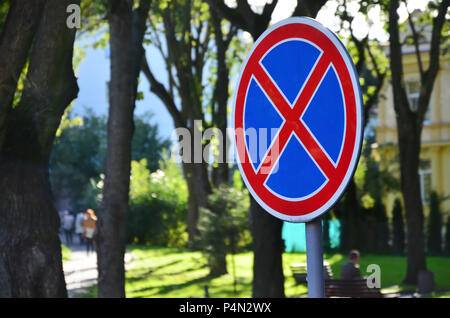 Round road sign with a red cross on a blue background. A sign means a ...