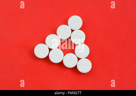 Red triangle pills Stock Photo - Alamy