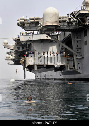 Sailors jump to the sea during a swim call aboard USS Carl Vinson Stock ...