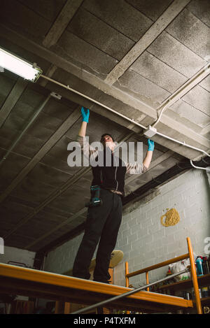 concentrated man working on an electrical installation Stock Photo - Alamy