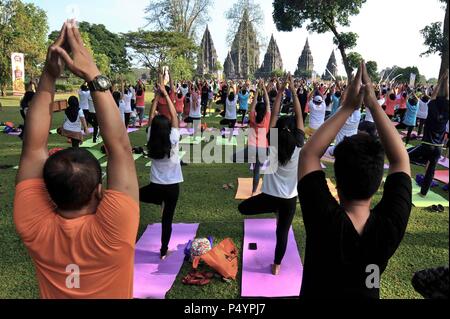 People participate in a mass yoga class during the "Times Square: Mind ...