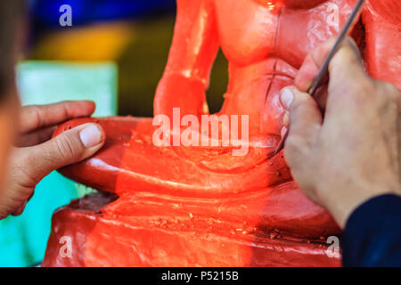 Sculptor carving the clay monk image. Thai sculpture artist molding and ...