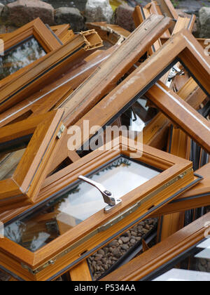 A pile of scrapped plastic wood effect ex window frames being replaced ...