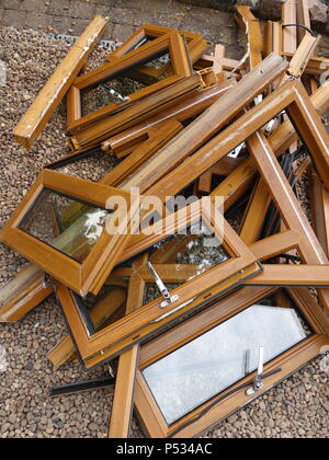 A pile of scrapped plastic wood effect ex window frames being replaced ...