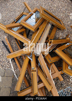 A pile of scrapped plastic wood effect ex window frames being replaced ...