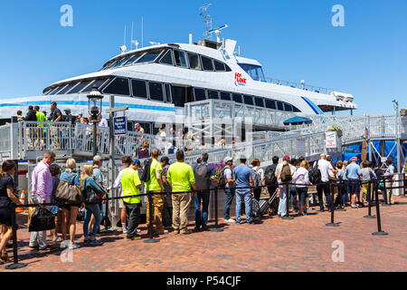Passengers board a Hy-Line Cruises high-speed catamaran ferry, bound ...