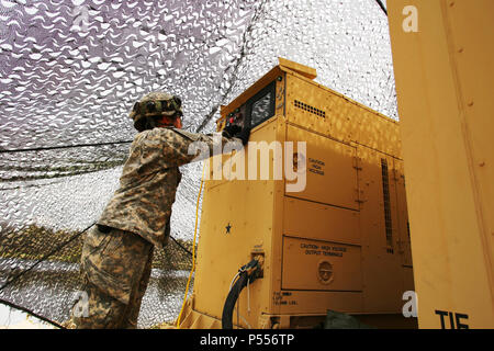 A US Army water purification unit is completing the supply water hookup ...