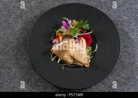 Crispy shark fin in black plate Stock Photo - Alamy