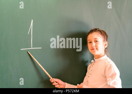Schoolgirl near green school board. High resolution photo Stock Photo ...