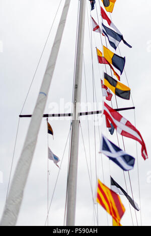 Colorful nautical sailing flags flying in the wind from the lines of a ...