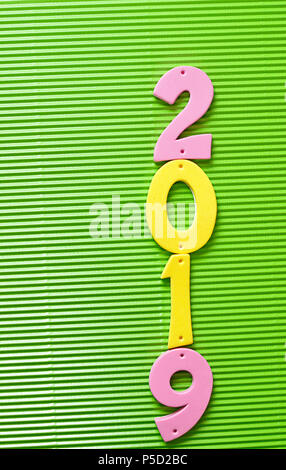 2019 in pink and yellow numbers on a purple background Stock Photo - Alamy