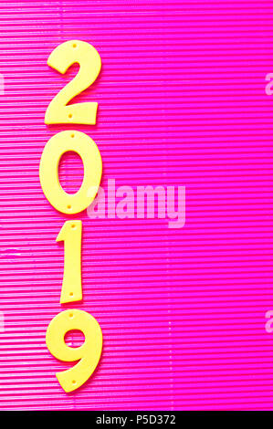2019 in pink and yellow numbers on an orange background Stock Photo - Alamy