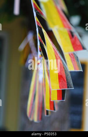 Gold red black colored paper pennons on the line Stock Photo - Alamy