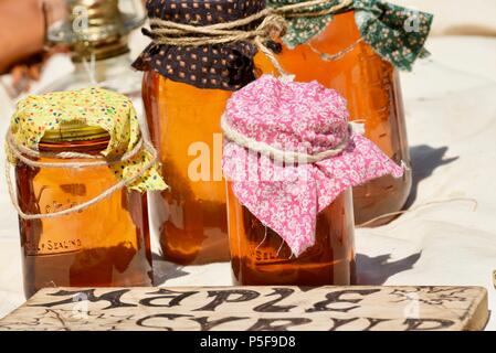 Maple syrup display. Jars, bottles, and cans of Canadian maple syrup on ...