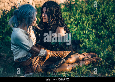 Fantasy cosplay two beautiful girls hug in nature Stock Photo - Alamy