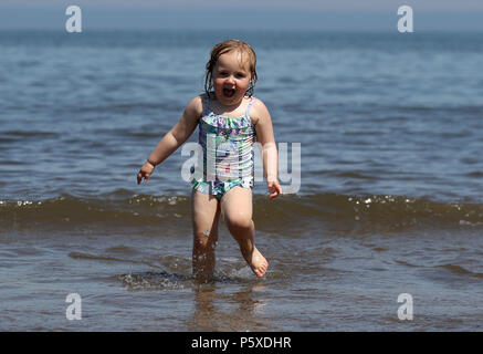 Harley Murray, aged 3, enjoys her first dip in the sea at Portobello ...