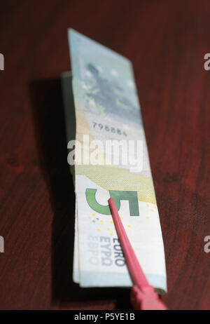 A folded Euro bill close-up Stock Photo - Alamy