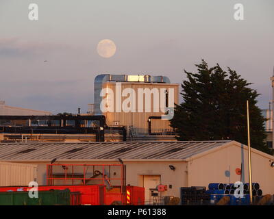 The strawberry full moon rises behind a church in Berlin, Germany ...