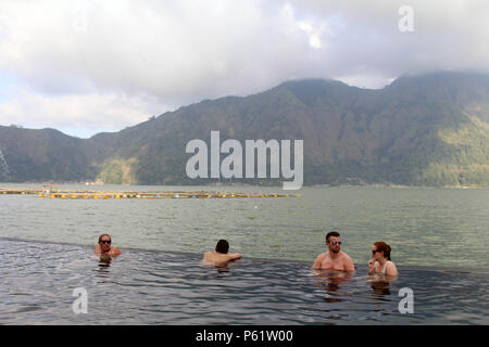 People are enjoying dipping in a hotspring (Toya Devasya), by the lake ...