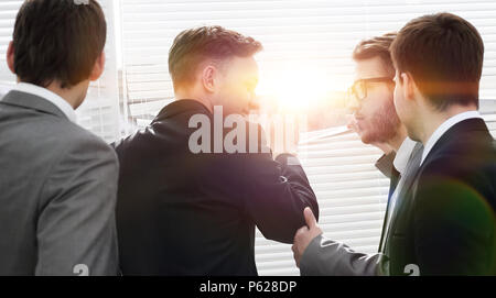 business partners communicate standing near window in office Stock ...