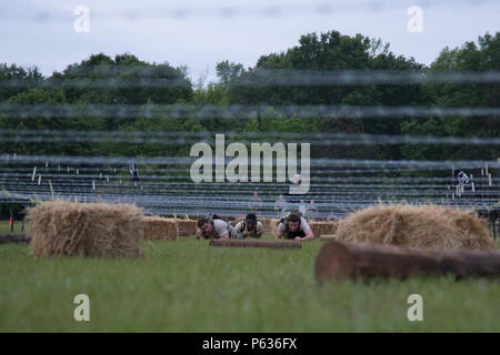 U.S. Army soldiers crawl under barbed wire during the team obstacle ...
