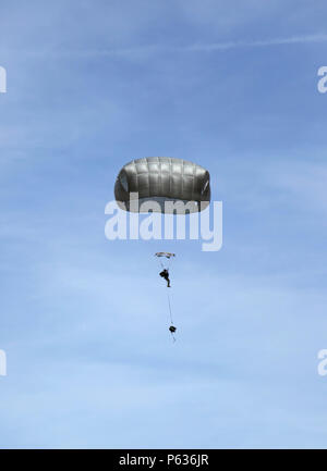 A paratrooper executes a static line jump at Sicily Drop Zone during ...