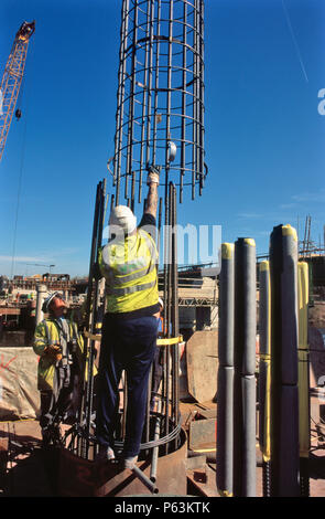 Lowering a reinforcement cage into a bored pile on a bridge foundation ...