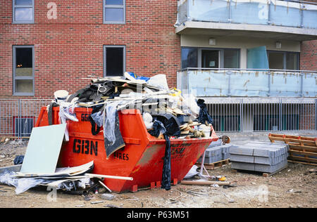 Overloaded skip on a building site - waste segregation Stock Photo - Alamy