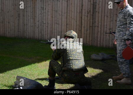 A German Soldier shoots an M4 carabine in prone position under ...