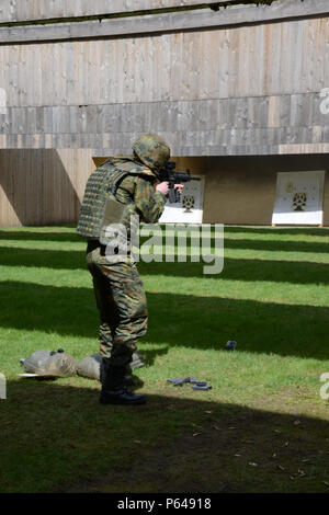 A German Soldier shoots an M4 carabine in prone position under ...