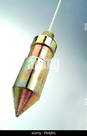 Close-up of a pendulum, construction tool on the table Stock Photo - Alamy