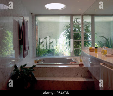 View of a bathtub in an eclectic bathroom Stock Photo - Alamy