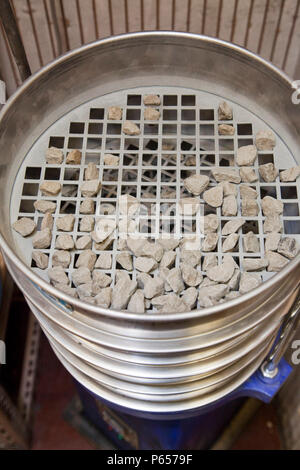 Sieves showing the different size materials from a test sample ...