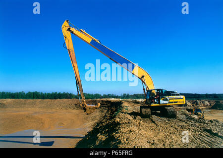 Excavation in progress with long reach excavator Stock Photo - Alamy
