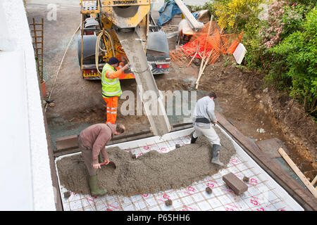 Pouring concrete for the floor of a house extension, Ambleside, UK ...