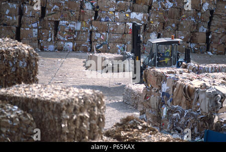 Forklift moving bales of waste paper ready for recycling Stock Photo ...