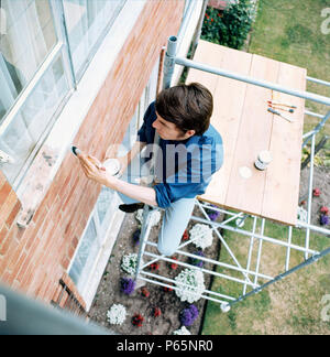 Man painting white windows Stock Photo - Alamy
