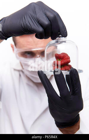 Holding chemical glass. Chemical scientist wearing headscarf holding ...