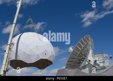 A crane removes the protective geodesic radar dome April 27, 2016, on ...