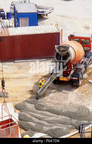 Mixer truck pouring concrete on a roadworks construction site in ...