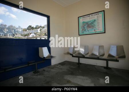 Seating and map inside the waiting shelter at Looe station at the end ...