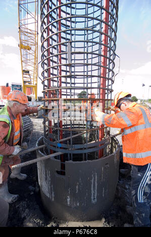Construction crew at work fitting reinforcing into the piling Stock ...