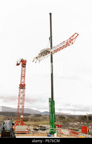 Crane lifting steel reinforced cage into an excavated pile. Concrete ...