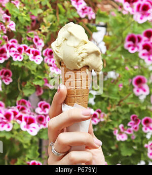 A woman places a dessert of cream and biscuit crumbs on the table ...