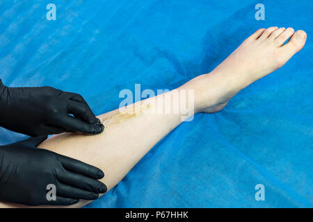 Depilation sugar processes woman passes in a beauty salon Stock Photo ...