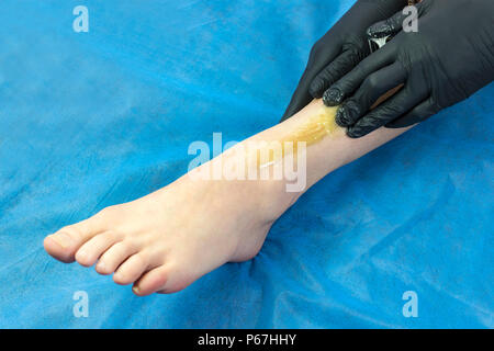 Depilation sugar processes woman passes in a beauty salon Stock Photo ...